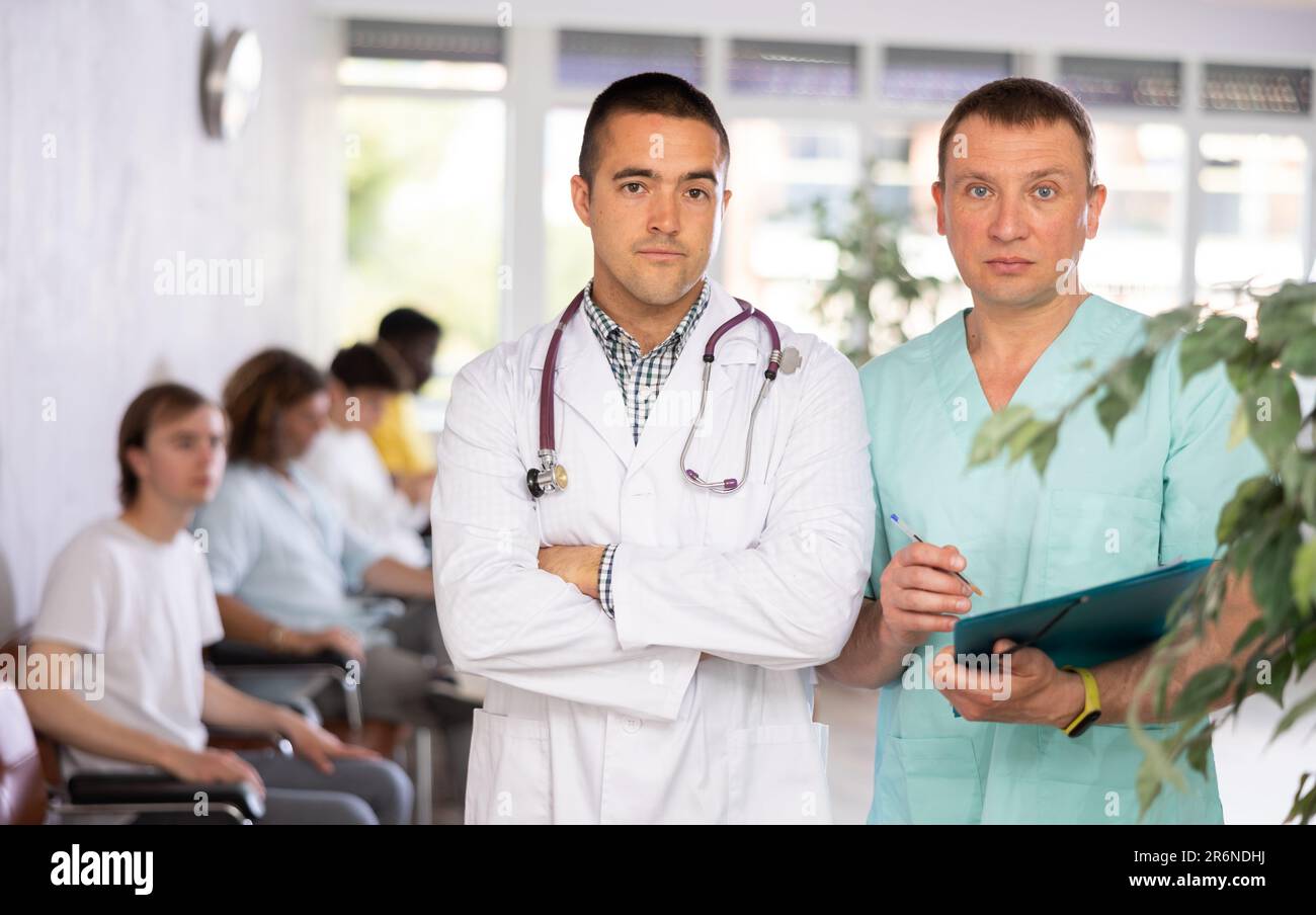 Two professional doctor colleagues standing in lobby of clinic Stock ...