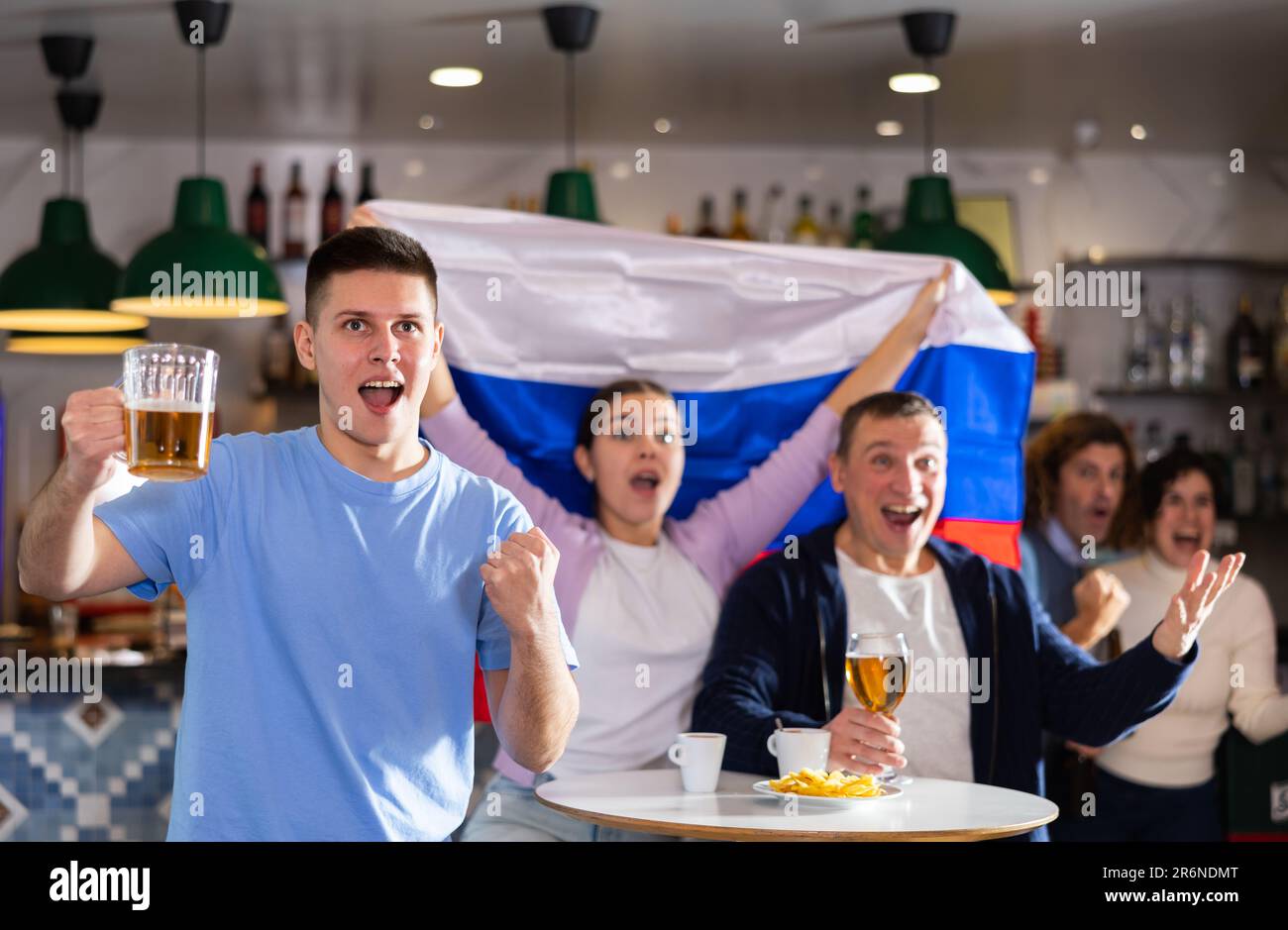 Happy friends of different ages drinking beer and celebrating the ...