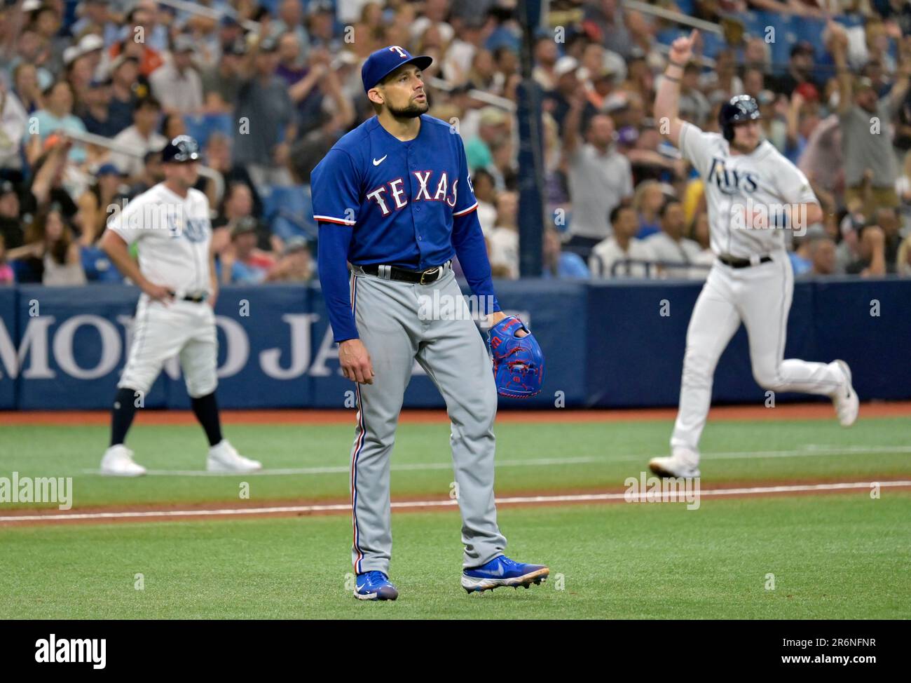 Texas Rangers starter Nathan Eovaldi, center, watches a three-run home ...