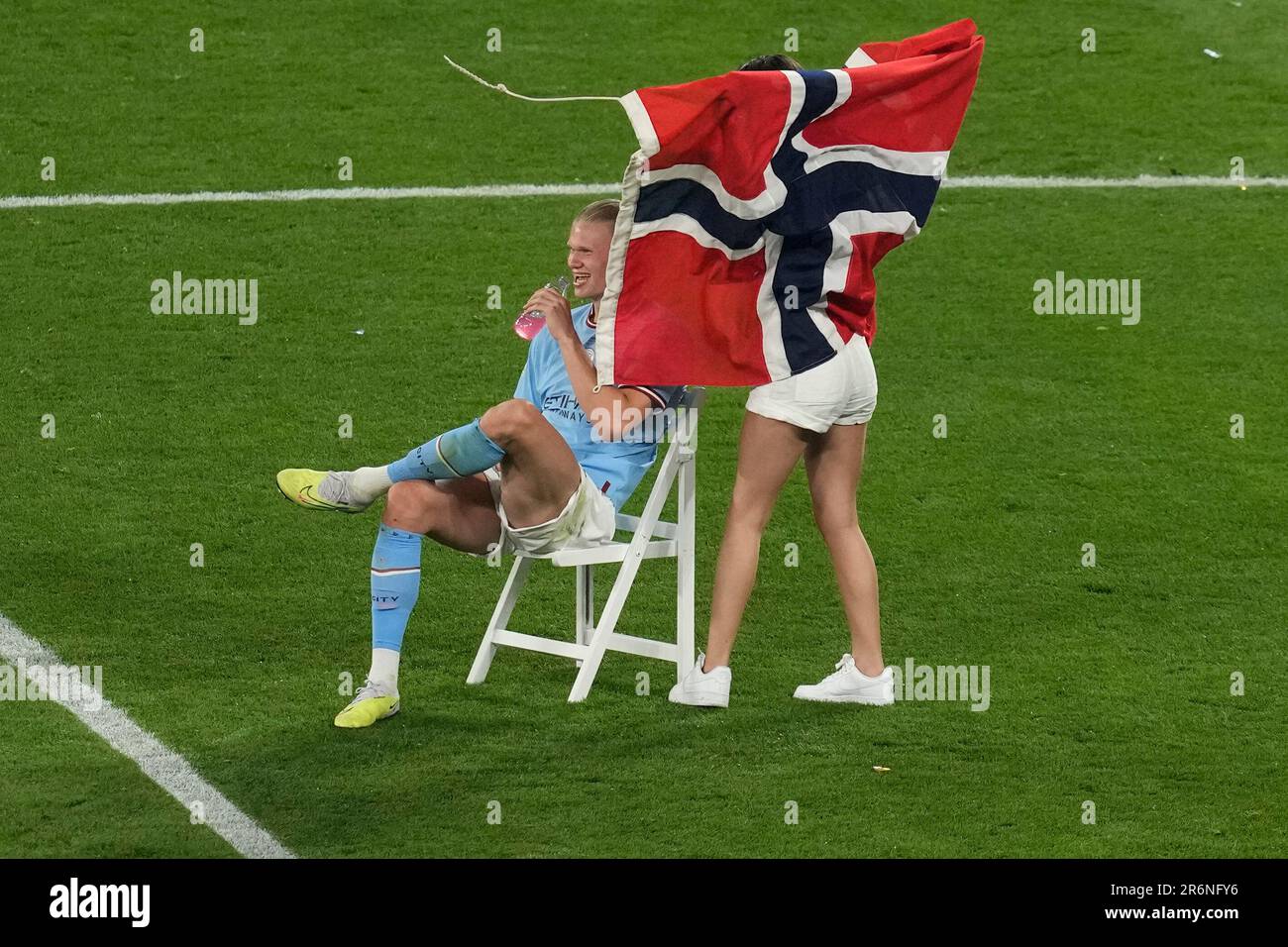 Manchester City's Erling Haaland smiles as he sits on the pitch after ...
