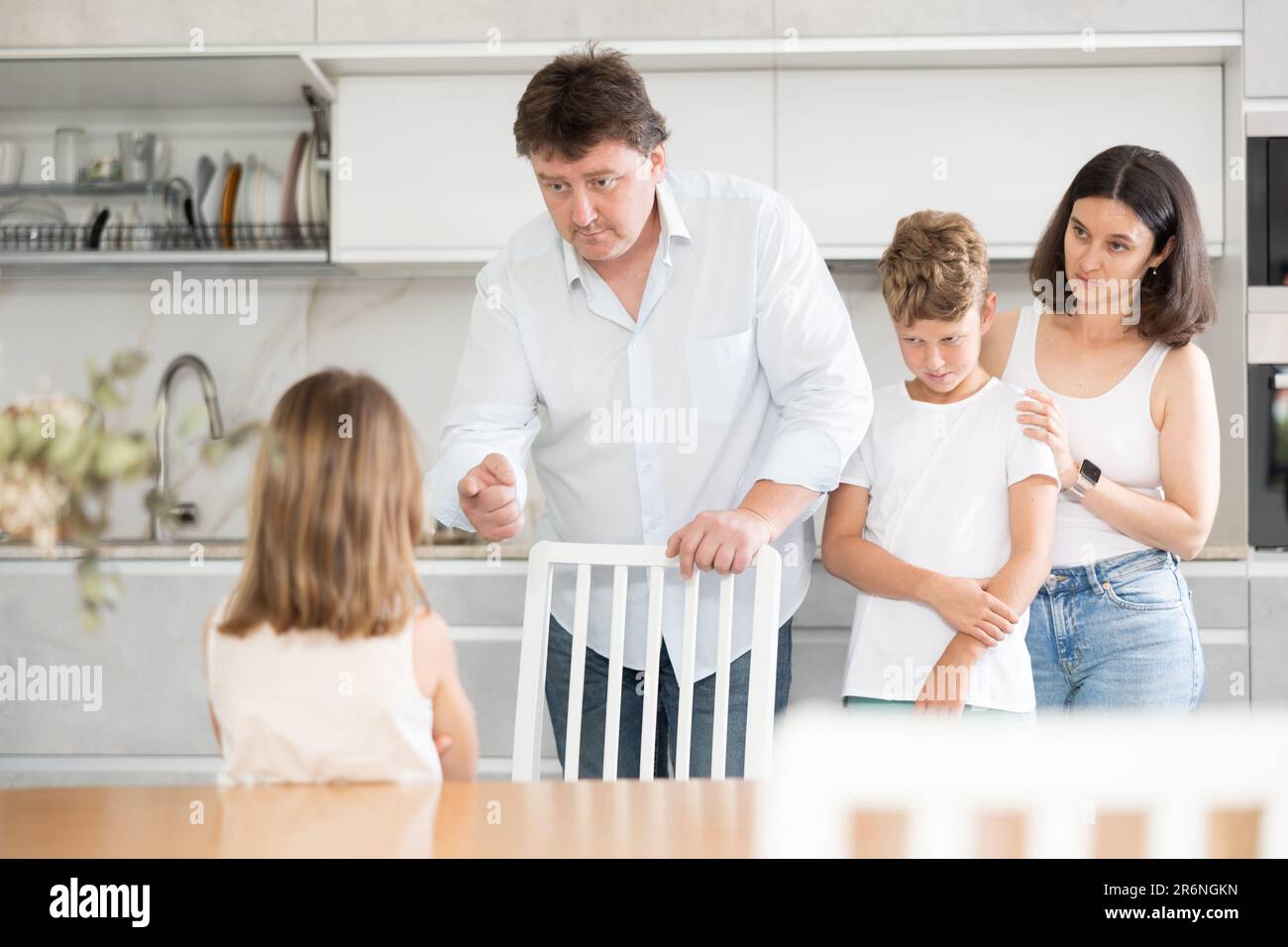 Father and mother telling off son and daughter for disobedience Stock ...