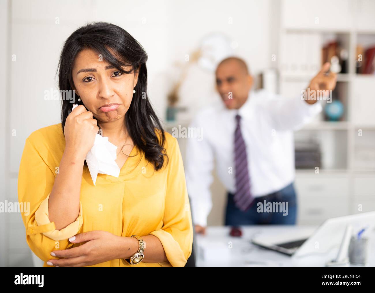 Upset woman crying in office after reprimand from chief Stock Photo - Alamy