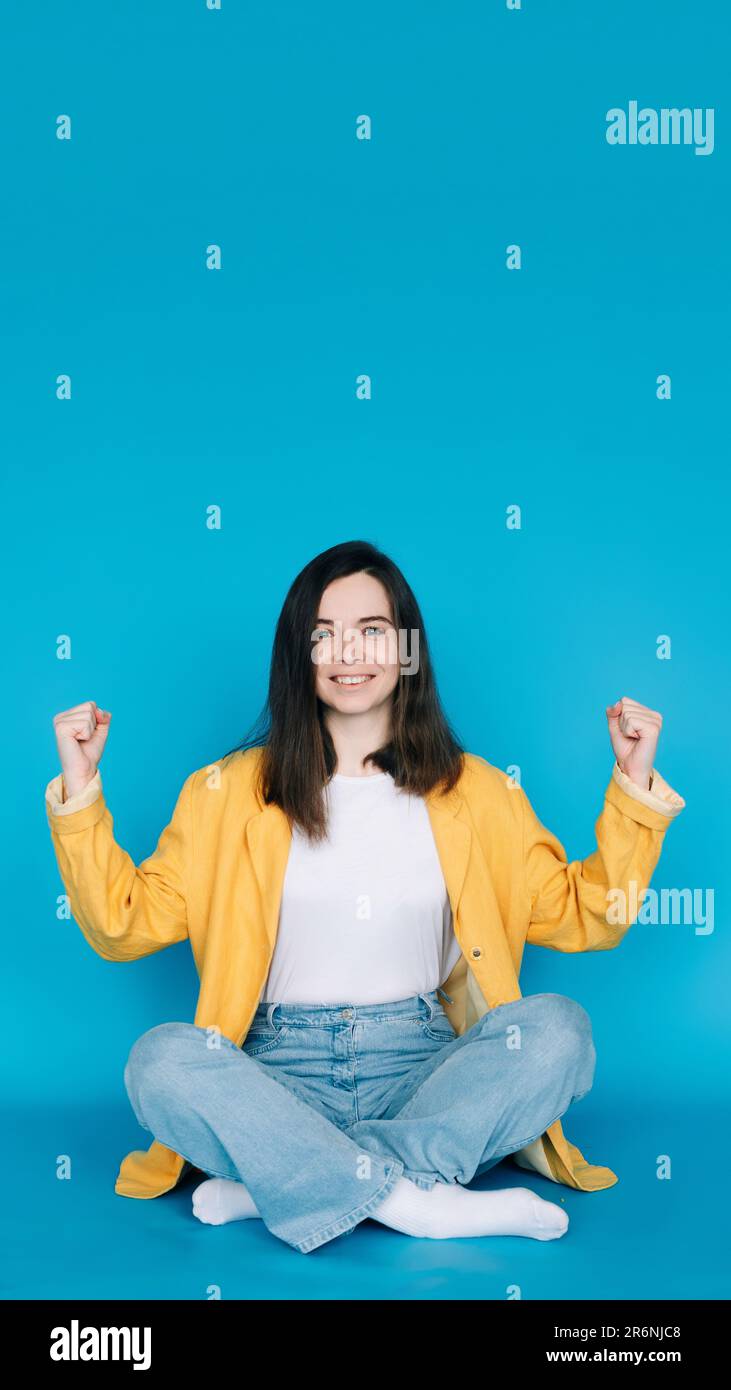 Energetic Young Woman Celebrating Success with Raised Fists, Exclaiming ...