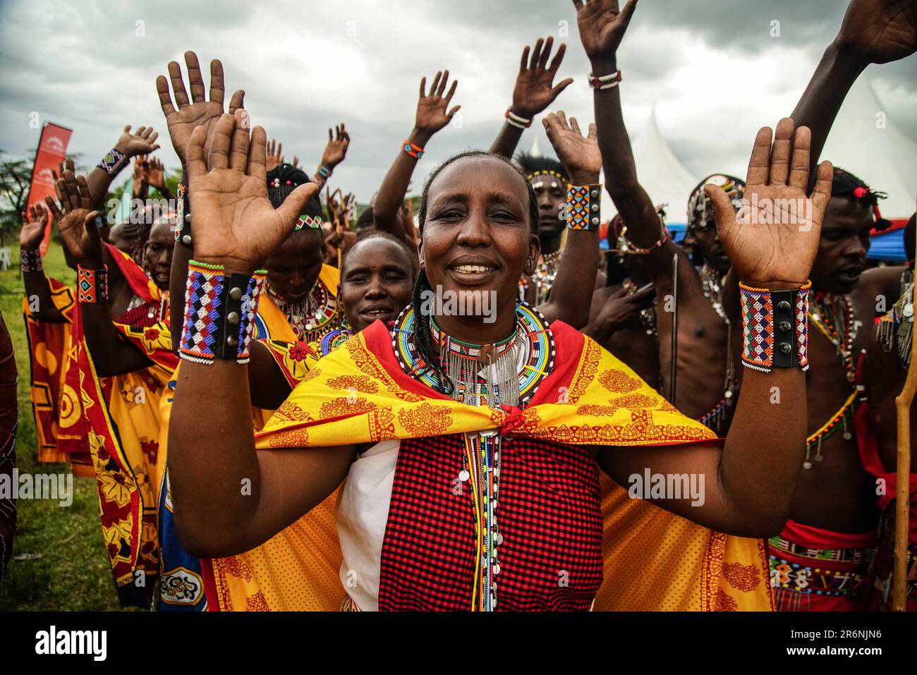 Narok, Kenya. 10th June, 2023. Maasai women wearing their traditional attires raise their hands ...