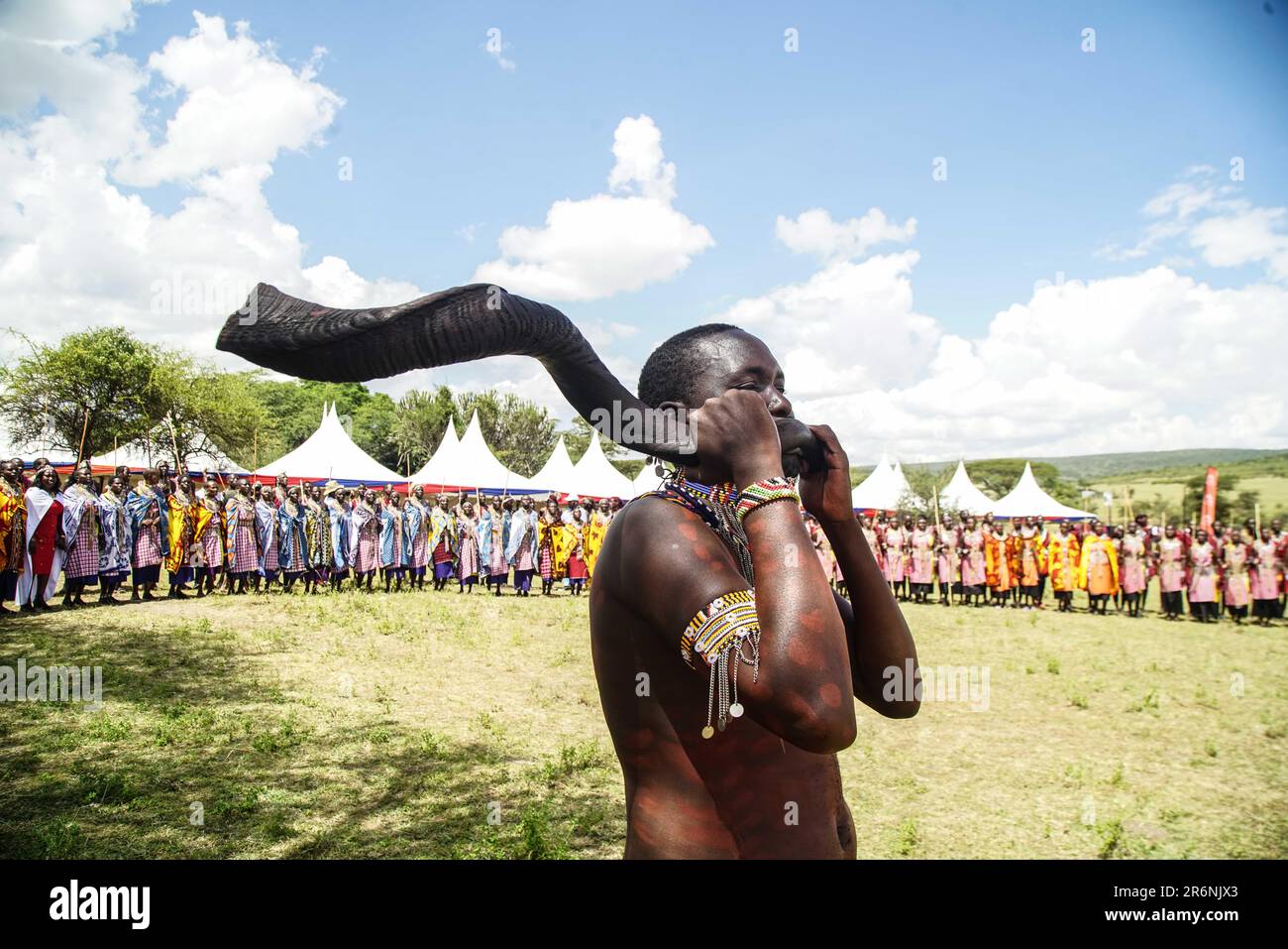 Narok, Kenya. 10th June, 2023. A Maasai man wearing their traditional attires blows a horn ...