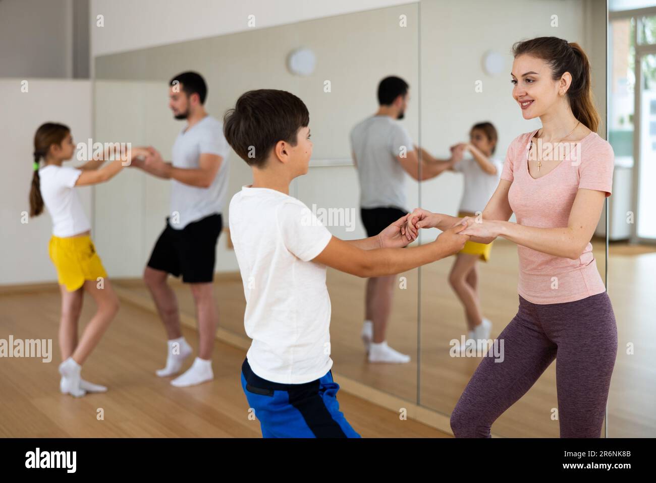Tween boy enjoying active dance in pair with mother Stock Photo - Alamy
