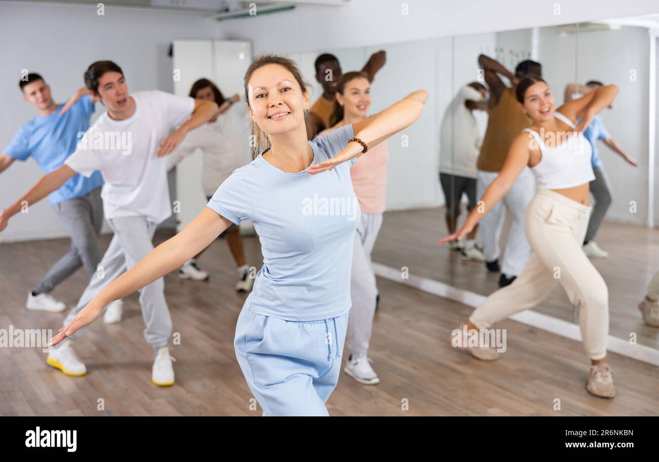 Happy active energetic multiracial dancers of different ages dancing ...