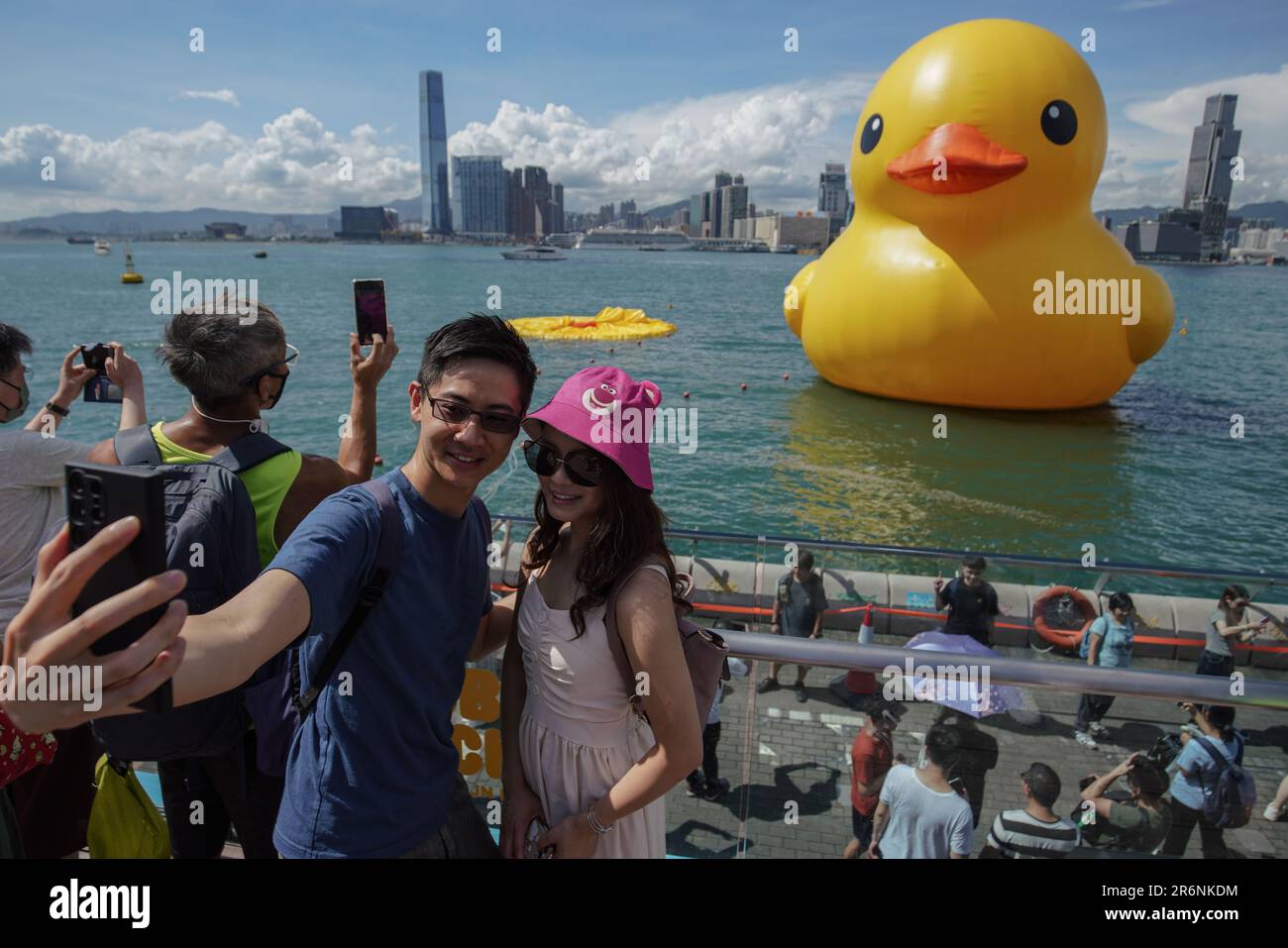 People take photos in front of an enormous inflatable duck which ...