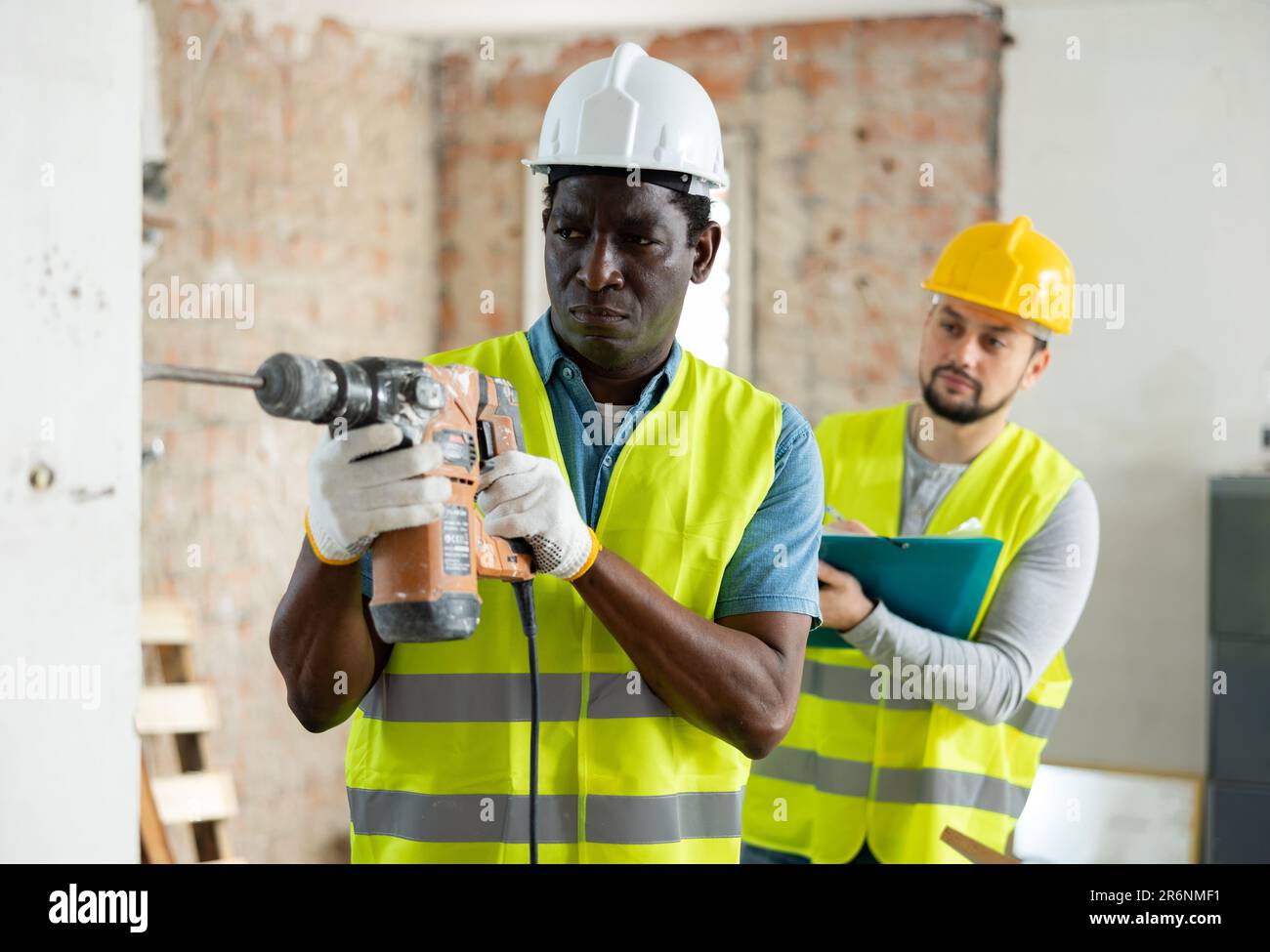 Man construction worker using demolition hammer in apartment Stock ...