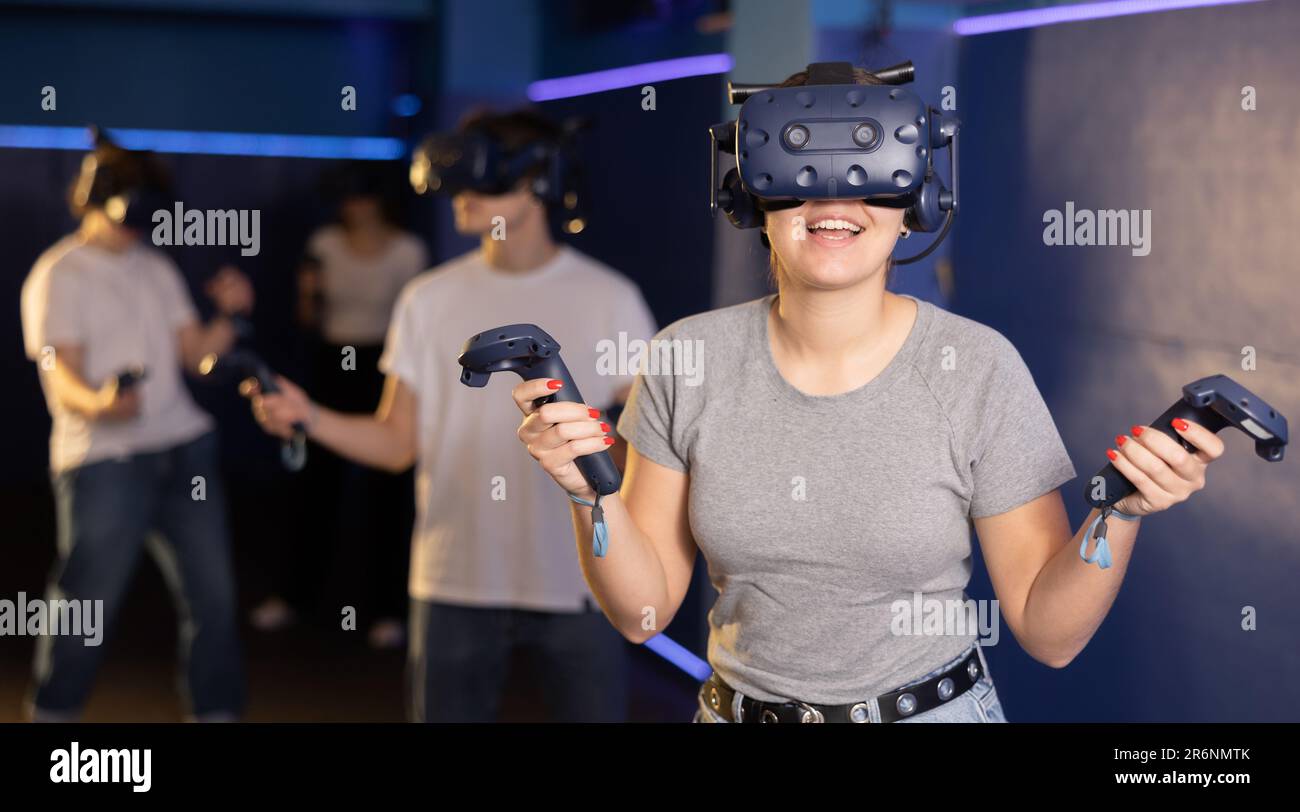 teenager in virtual reality glasses with joystick play survival game in ...