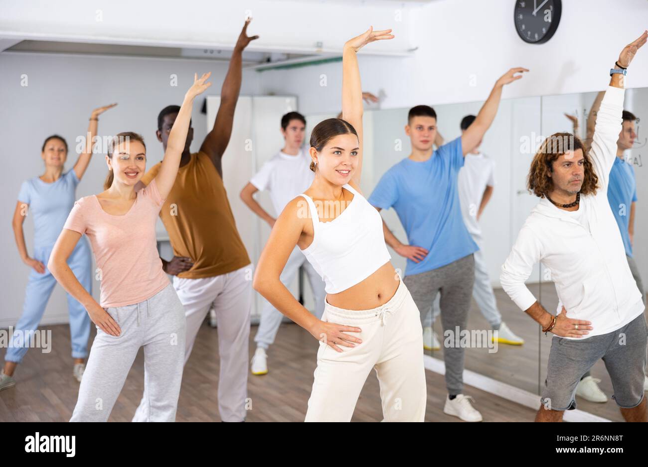 Group of different people rehearsing dance in dance studio Stock Photo ...