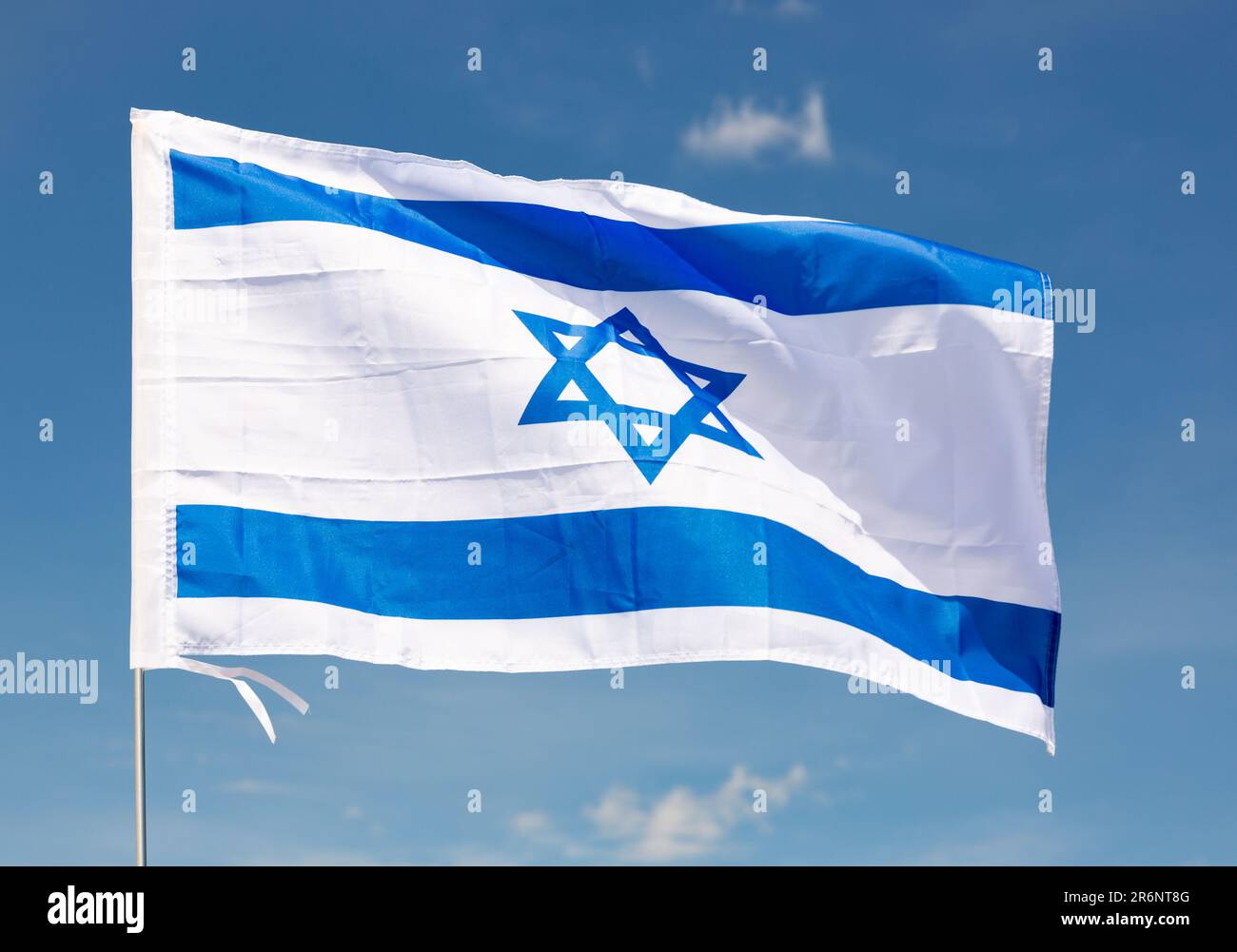 Flag of Israel waving on cloudy sky during daytime Stock Photo - Alamy