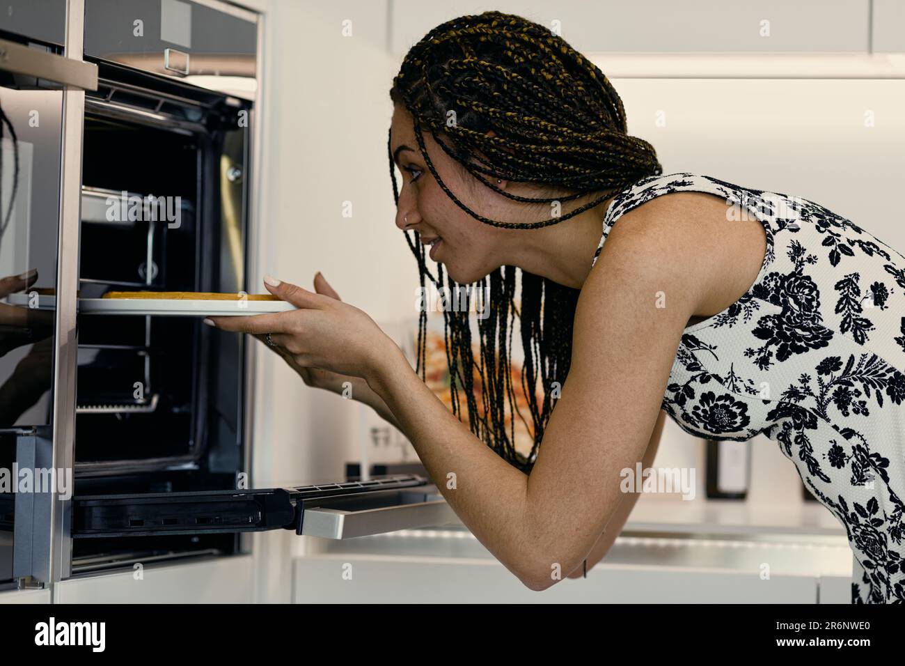 Proud and joyful chef in her radiant kitchen. She has completed a meal ...
