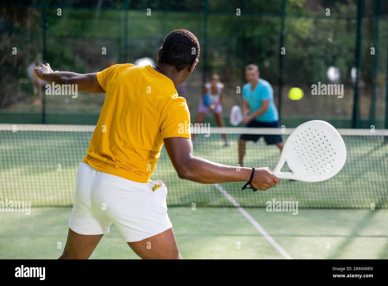 Rear photo of man playing padel tennis on court Stock Photo - Alamy