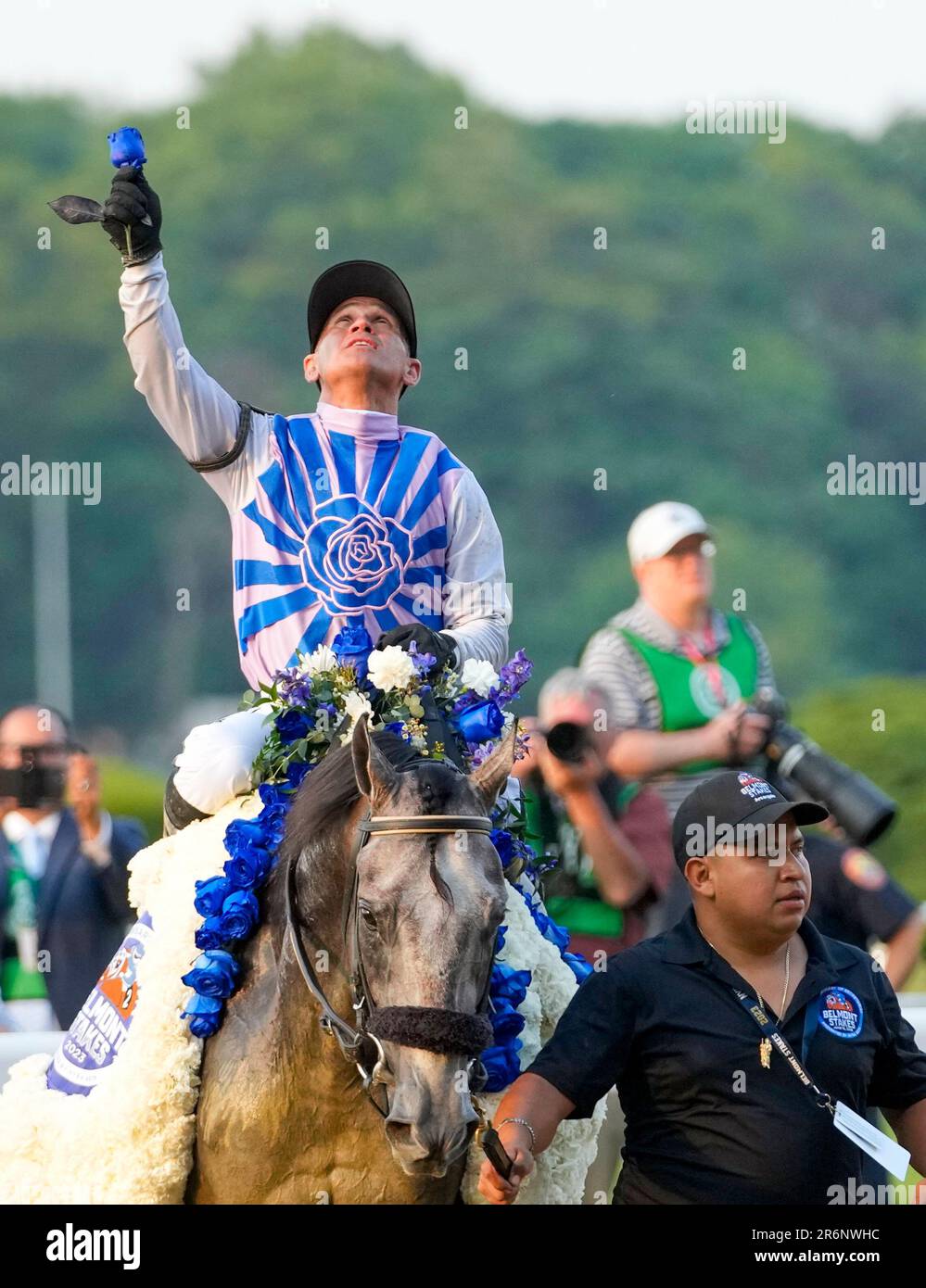 Jockey Javier Castellano holds up a blue rose as he celebrates aboard ...