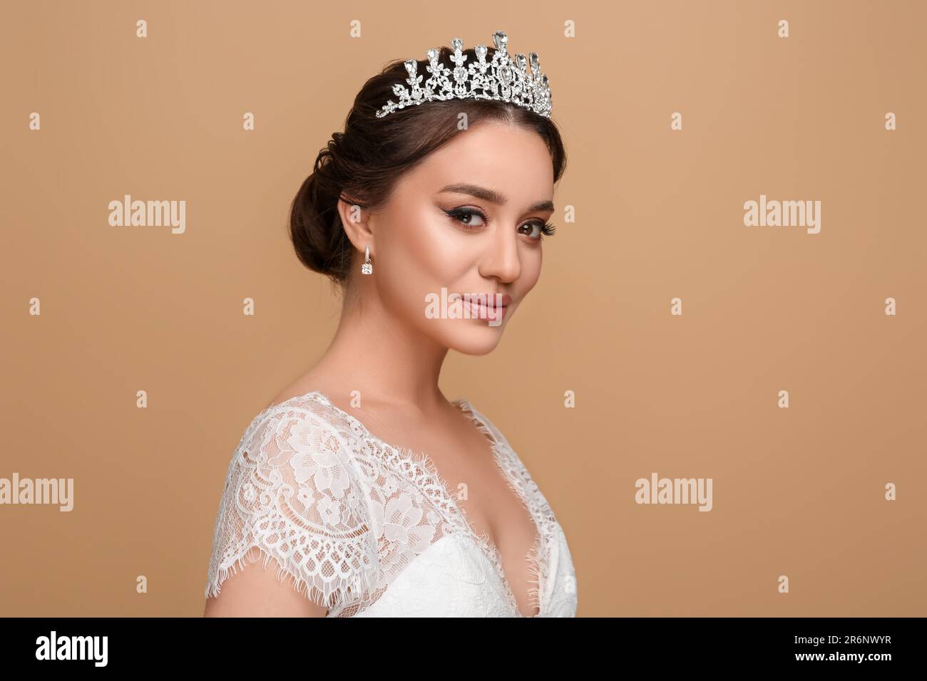 Beautiful young woman wearing luxurious tiara on beige background Stock ...