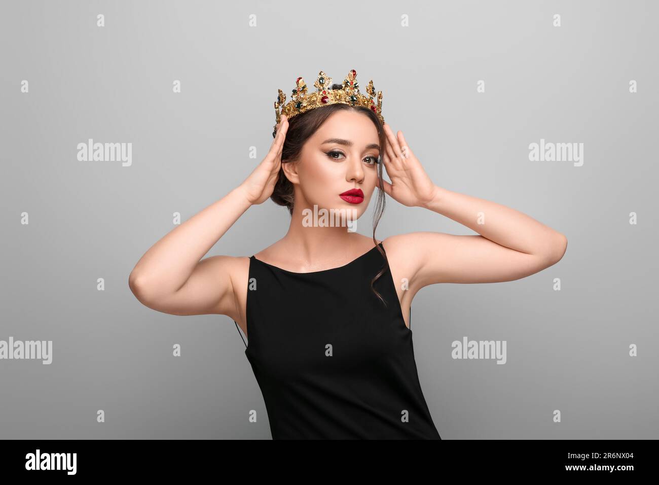 Beautiful young woman wearing luxurious crown on light grey background Stock Photo - Alamy