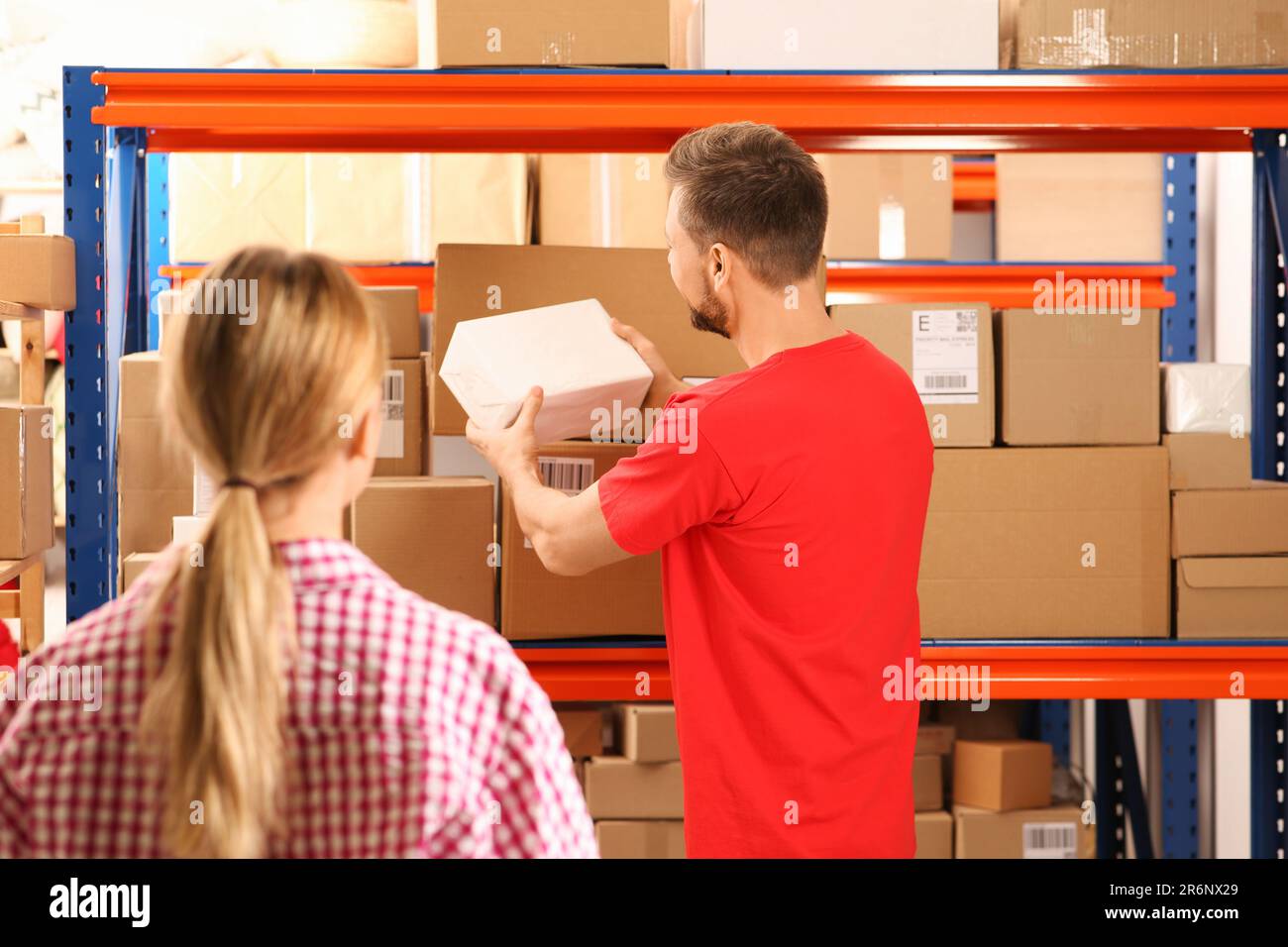 Woman delivery courier taking boxes hi-res stock photography and images ...