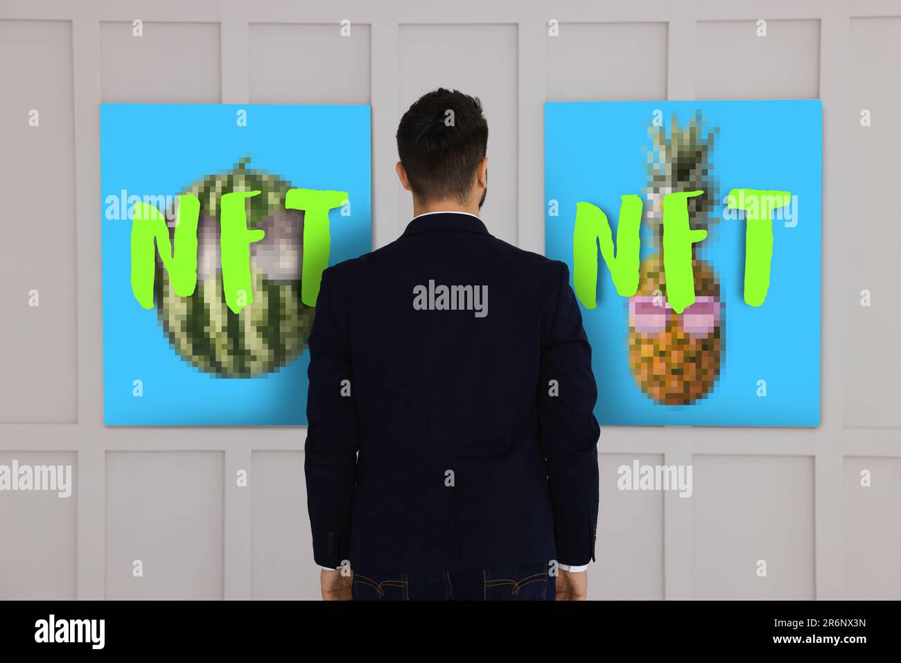 Man near art images in gallery, back view. Pictures with abbreviations ...