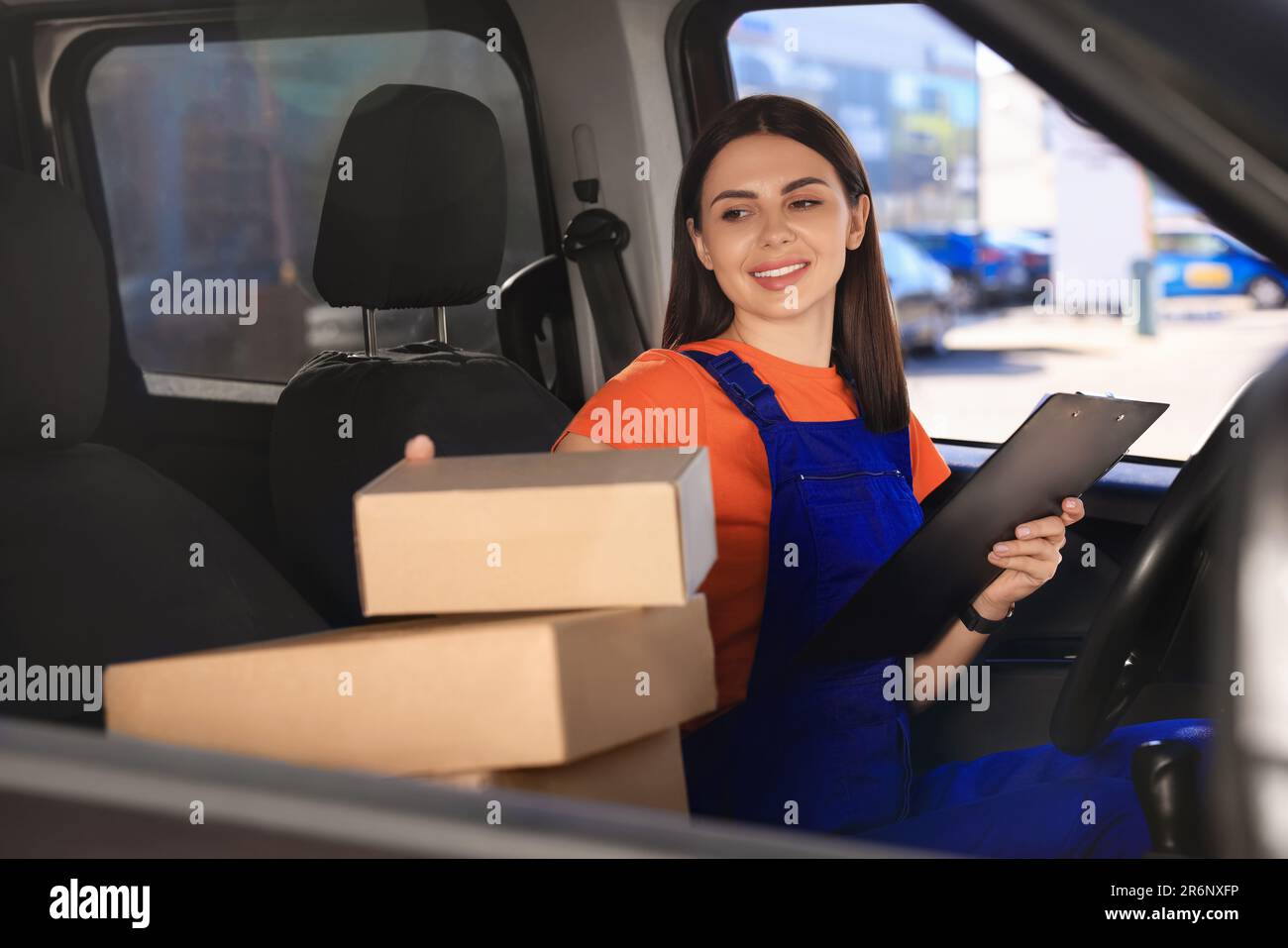 Female courier checking packages hi-res stock photography and images ...