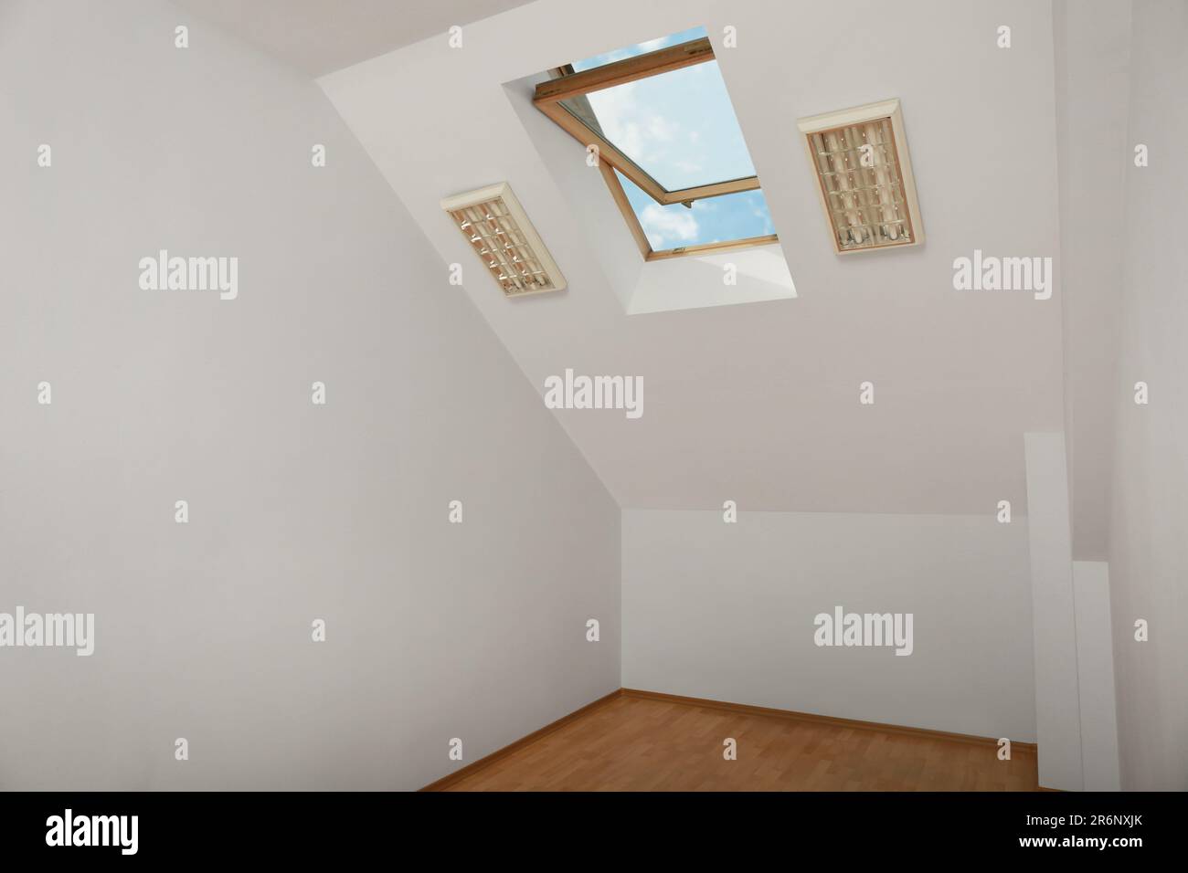 Light spacious attic room with roof window on slanted ceiling Stock ...