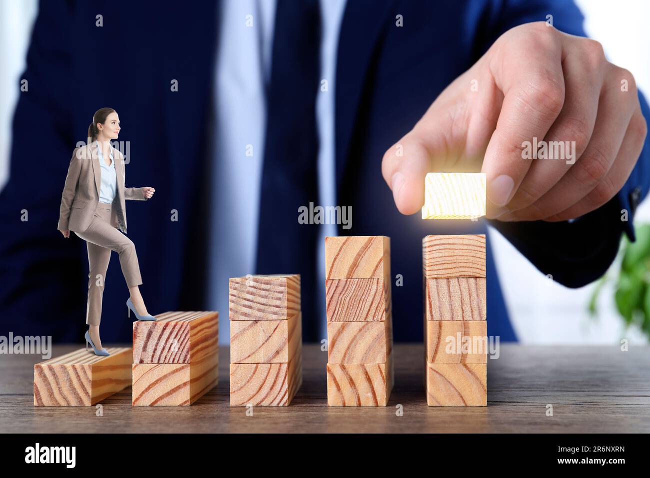 Steps to success. Businesswoman climbing up stairs of wooden blocks ...