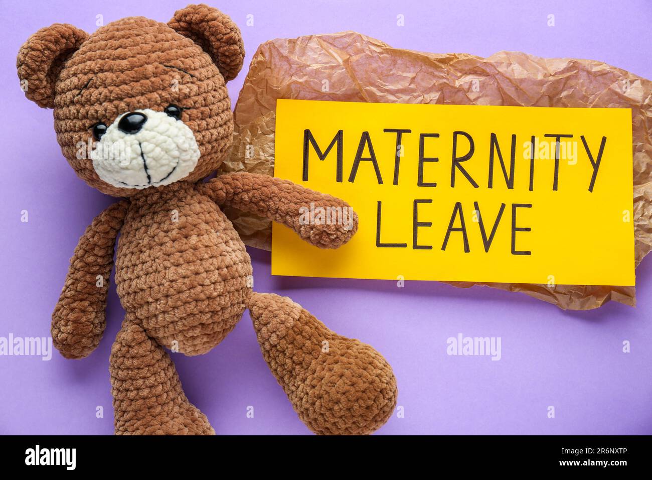 Toy bear and note with text Maternity Leave on violet background, flat ...