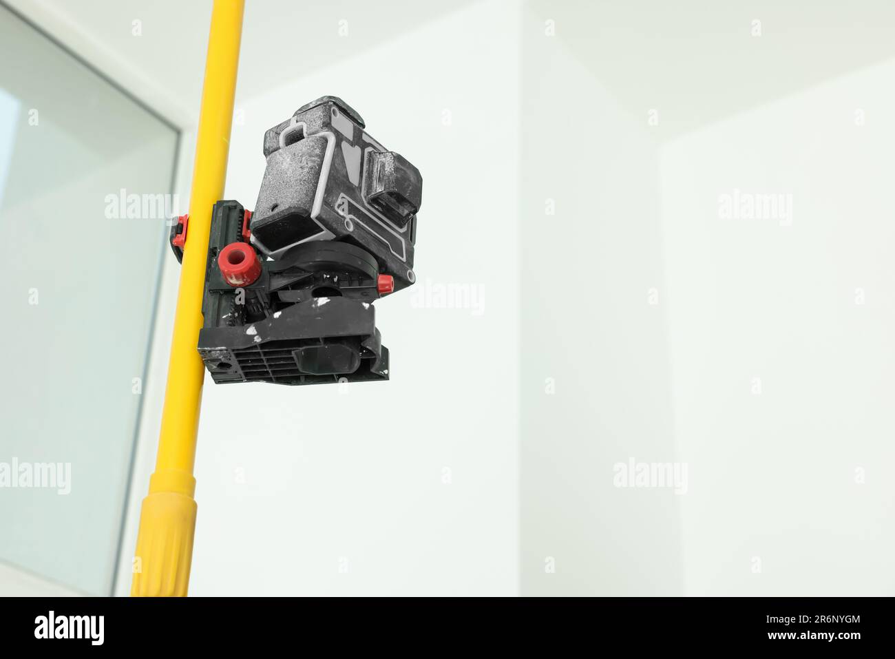 Modern cross line laser level indoors, space for text. Tiles ...