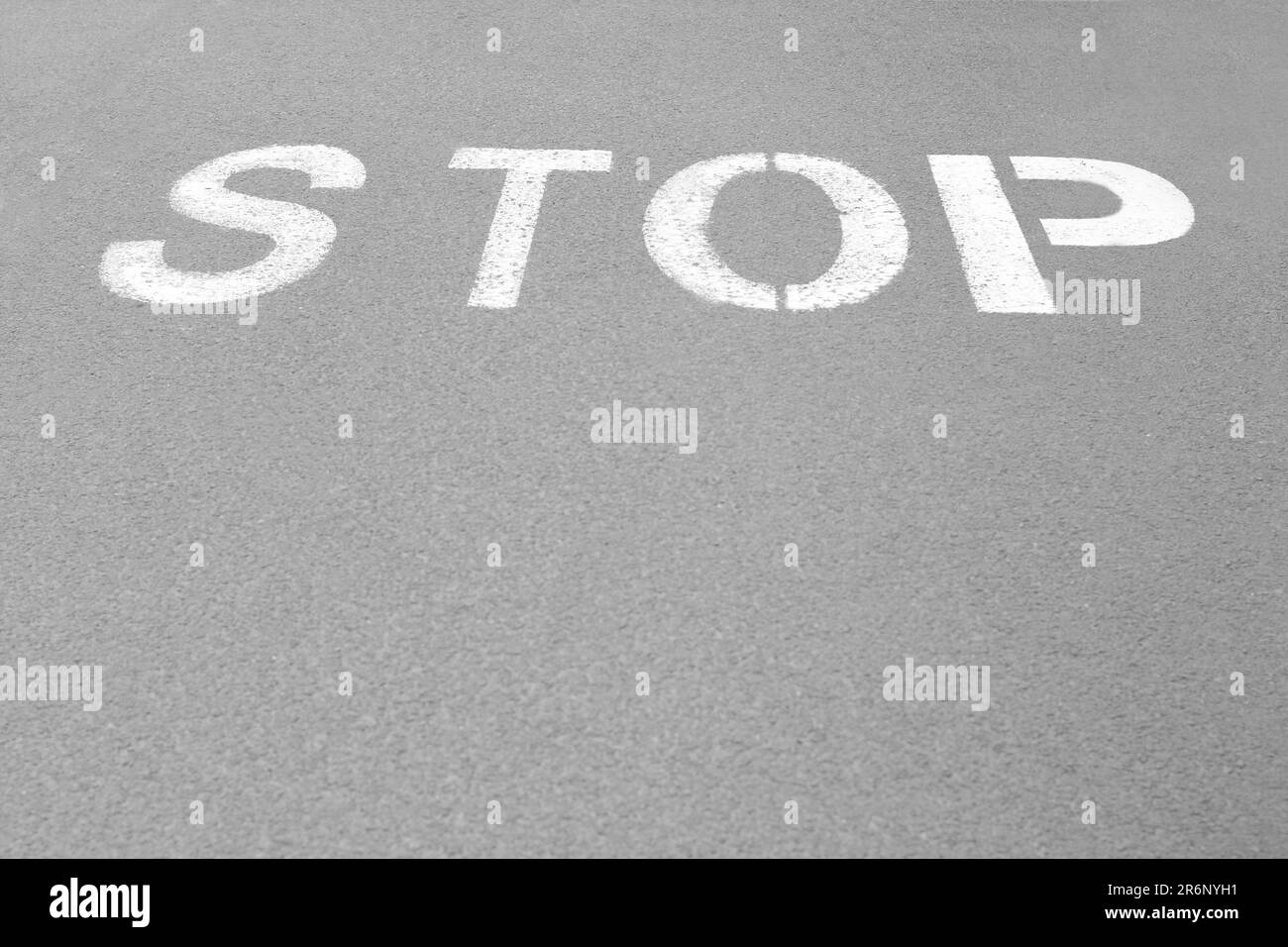 White sign Stop written on asphalt road in city Stock Photo - Alamy