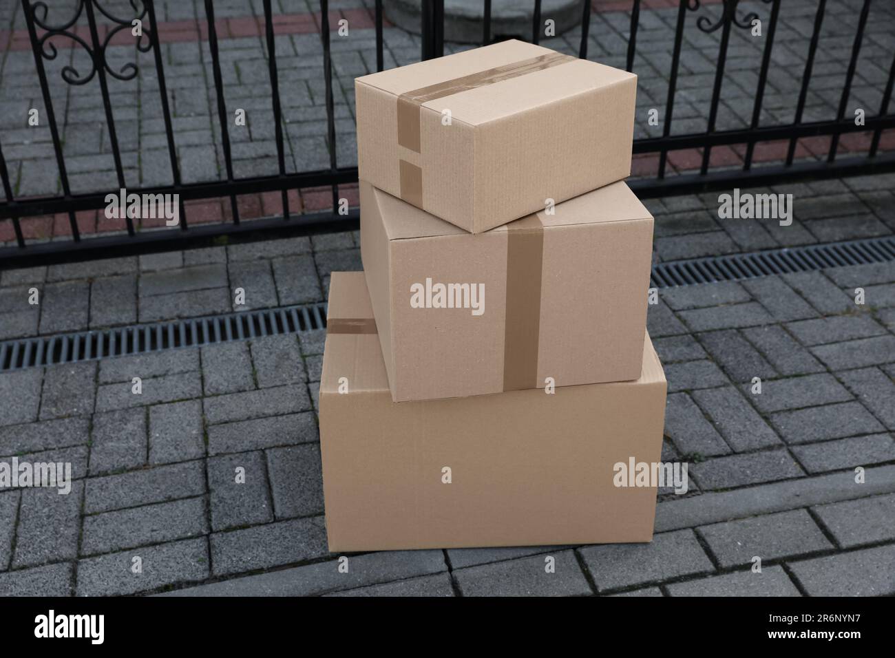 Stack of parcels delivered near front gates Stock Photo - Alamy