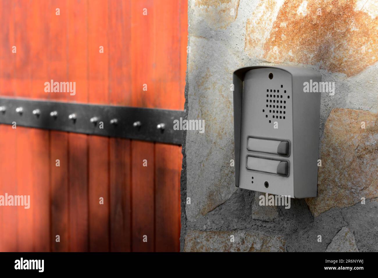 Modern intercom on textured wall with stone fragments outdoors Stock ...