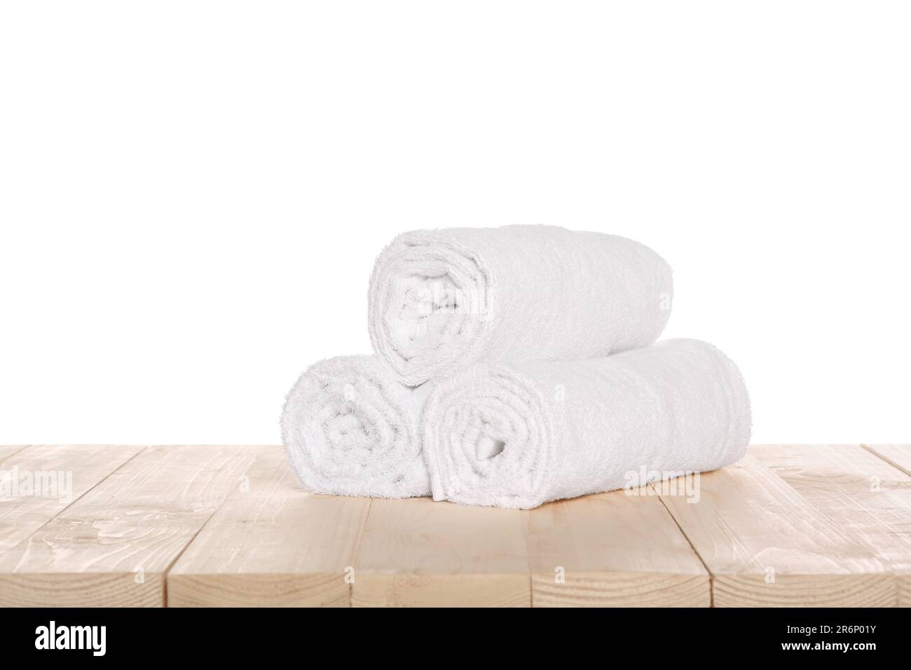 Soft terry towels on wooden table against white background Stock Photo ...