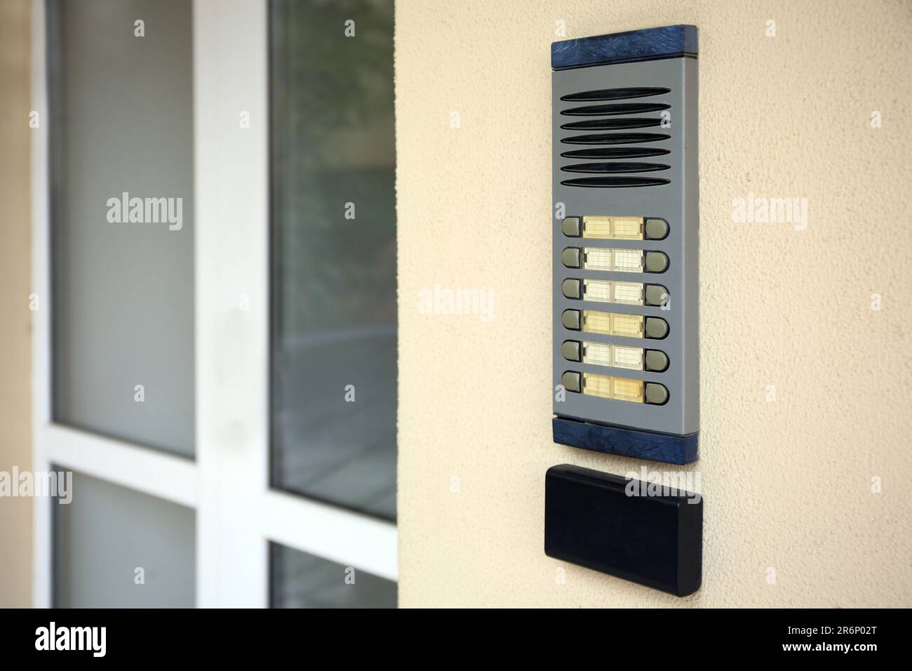 Modern intercom on beige wall near door outdoors, space for text Stock ...