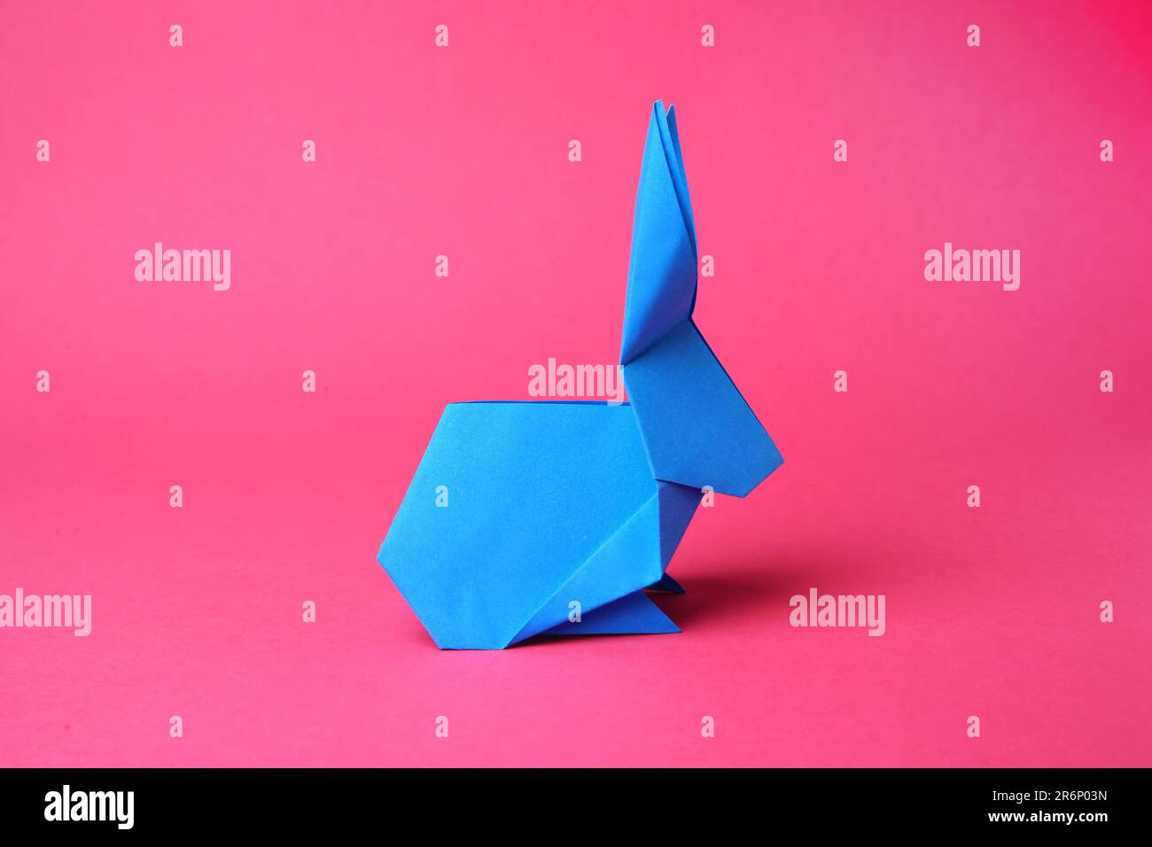 Light blue paper bunny on pink background. Origami art Stock Photo - Alamy