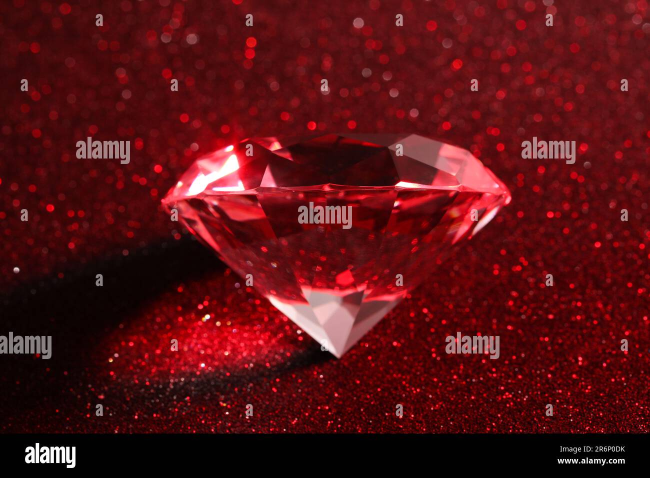 Beautiful shiny diamond on red glitter background Stock Photo - Alamy