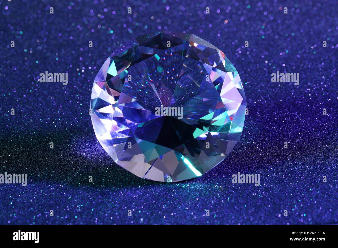 Beautiful dazzling diamond on blue glitter background Stock Photo - Alamy