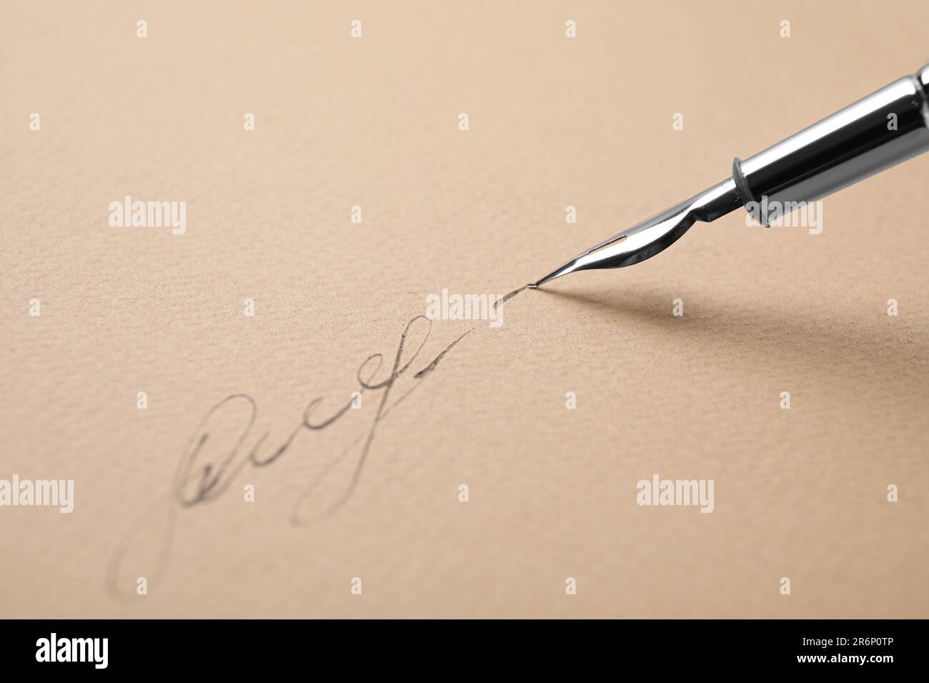 Signing on sheet of paper with fountain pen, closeup. Space for text ...