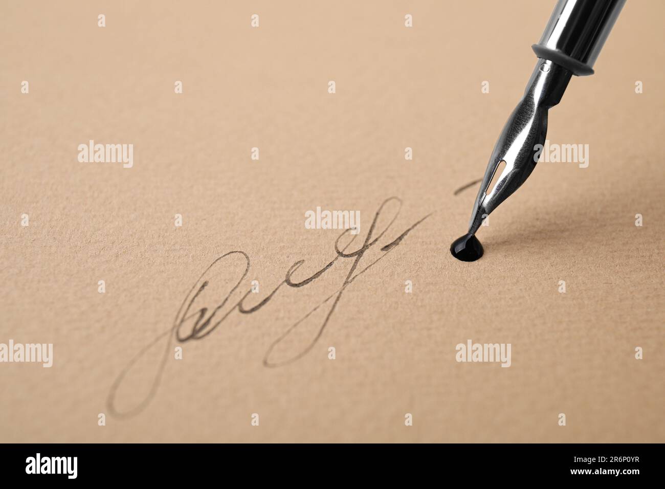 Signing on sheet of paper with fountain pen, closeup. Space for text ...