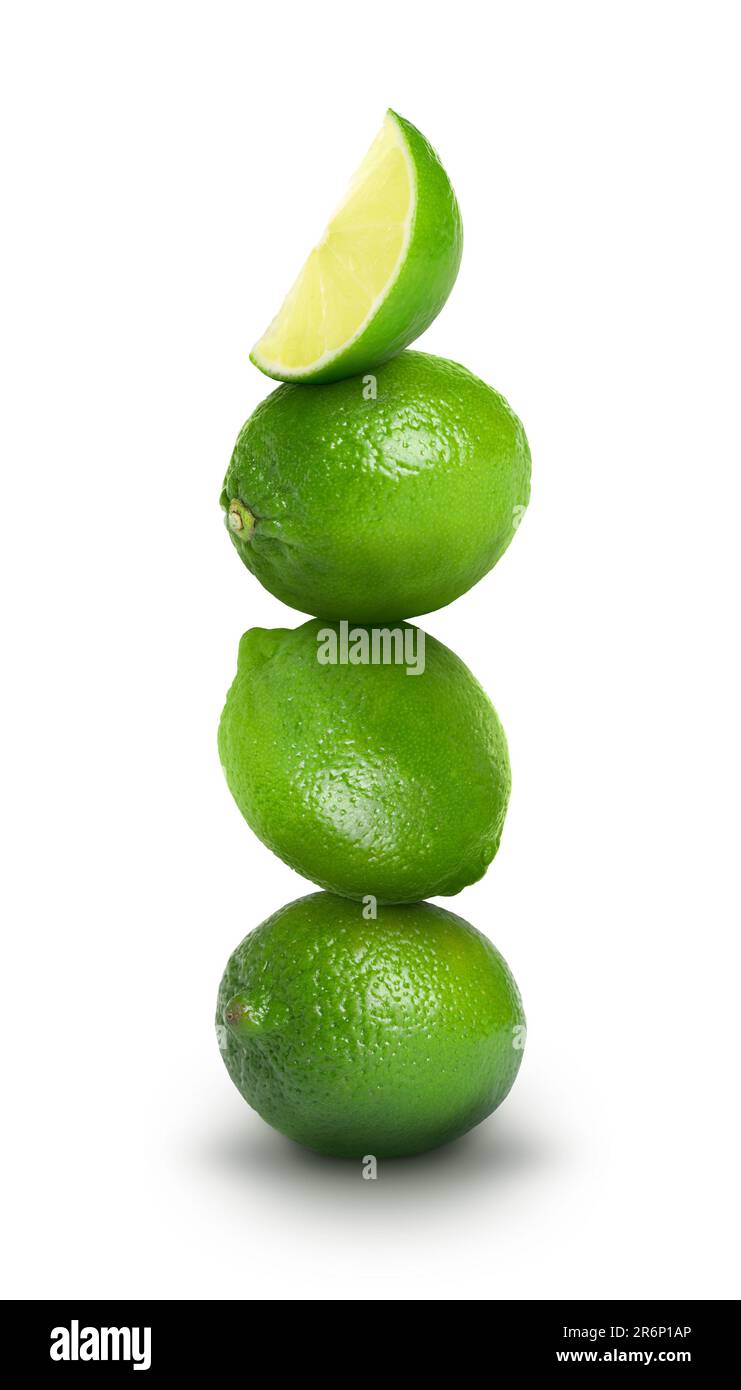 Stacked whole and cut limes on white background Stock Photo - Alamy