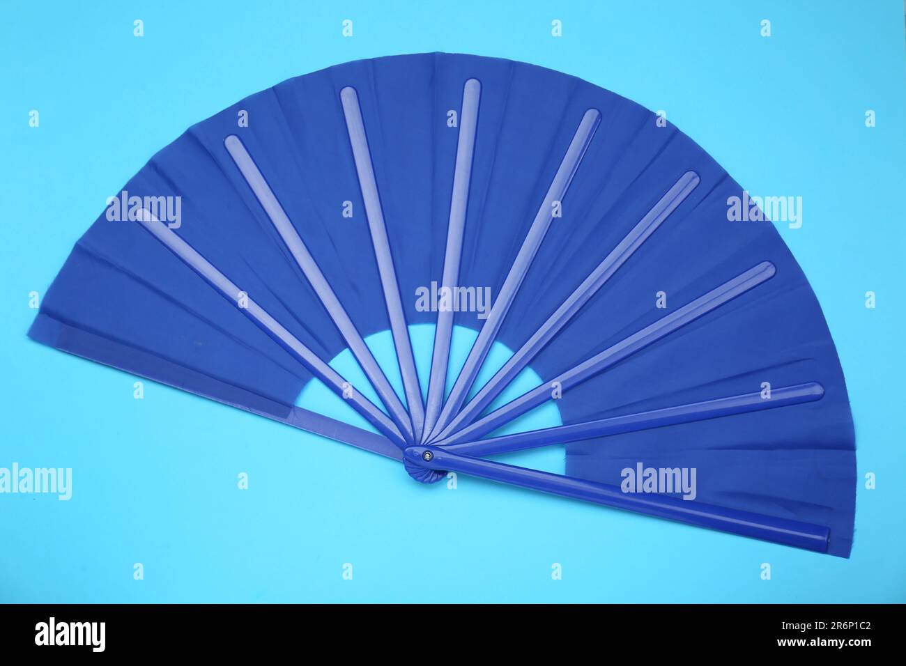 Bright color hand fan on light blue background, top view Stock Photo ...