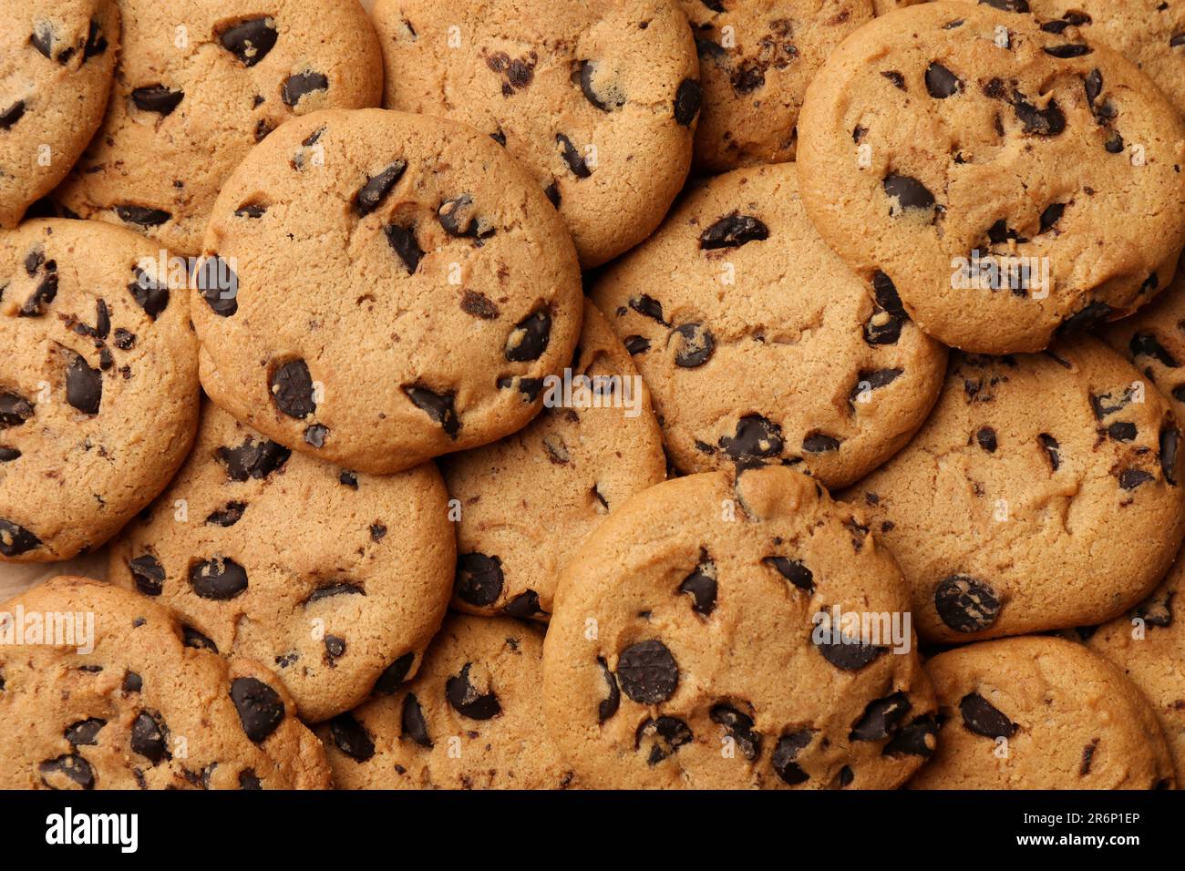 Delicious chocolate chip cookies as background, top view Stock Photo ...