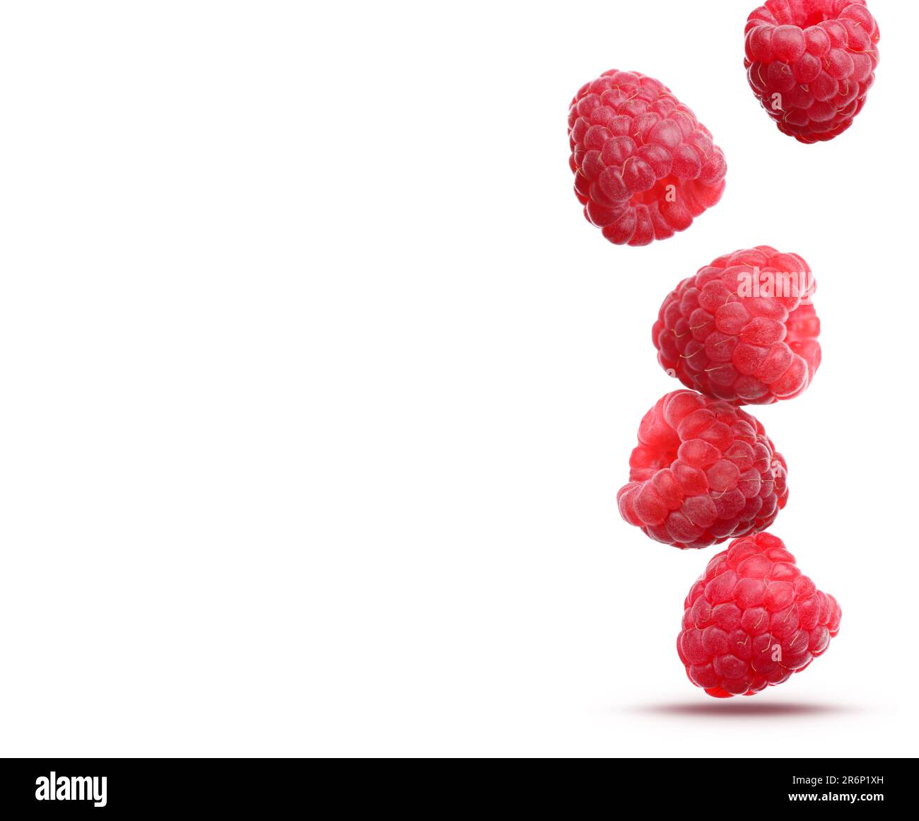 Fresh ripe raspberries falling on white background Stock Photo - Alamy