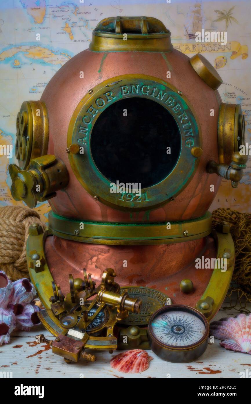 Diving Helmet And Old Map With Compass Still Life Stock Photo - Alamy