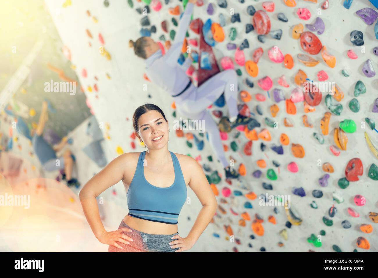 Portrait of slender smiling woman climber on background of climbing ...