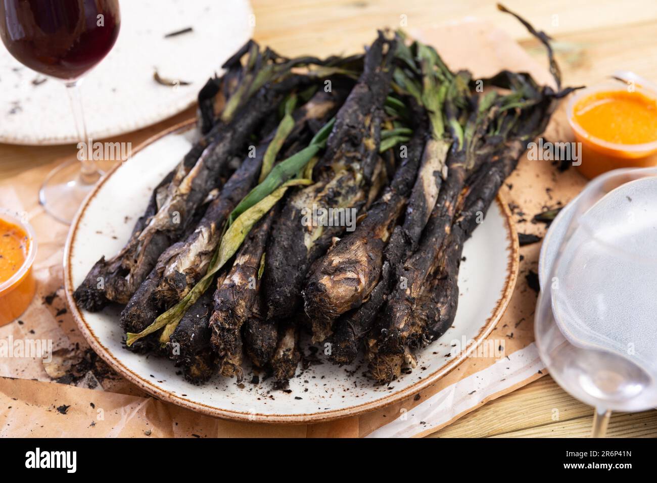 A traditional catalan dish of charred calcot onion and romesco sauce ...