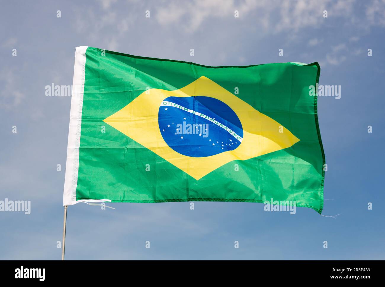 Brazil flag waving against blue sky Stock Photo - Alamy