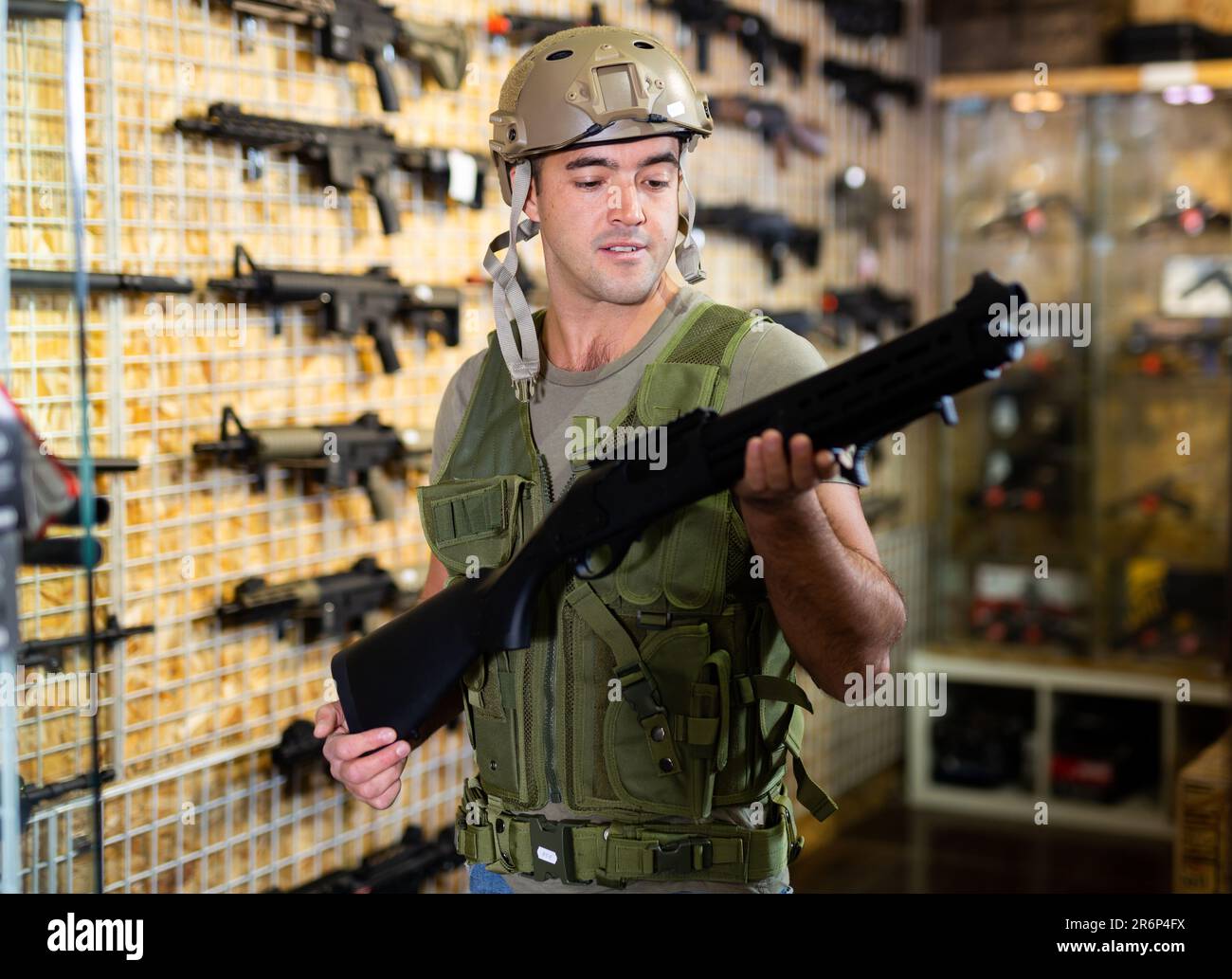 Man in army uniform with weapon in military market Stock Photo - Alamy