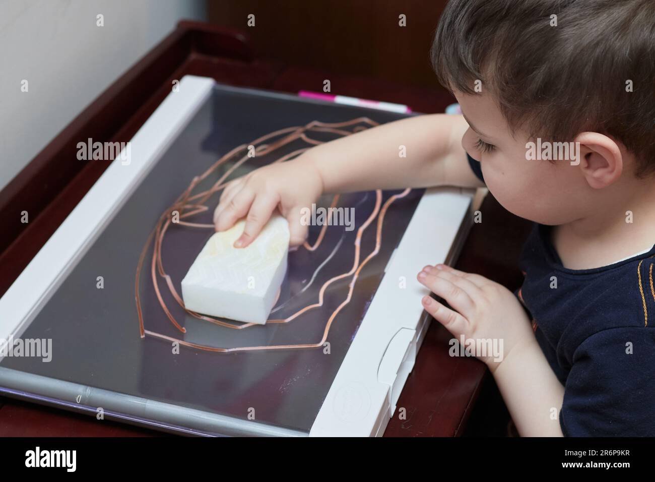 toddler drawing with markers on a plastic light board Stock Photo - Alamy