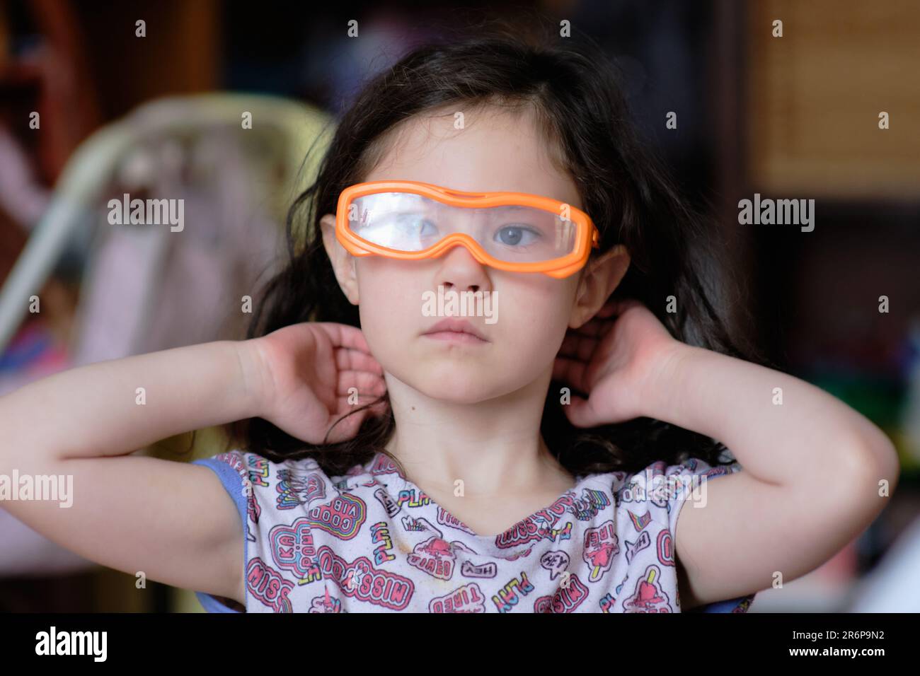 young girl in pajamas playing with toy 3d glasses Stock Photo - Alamy