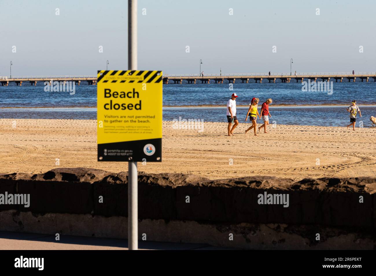 People enjoying a walk on the beach despite recent beach closures due ...